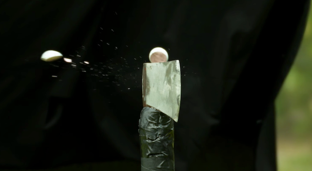 Watch a golf ball get split in half when it's driven into an axe blade ...